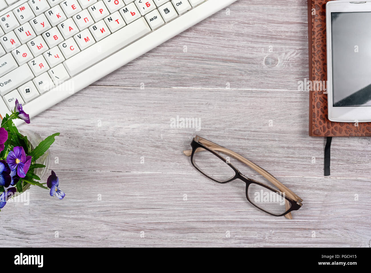 Office wooden table, PC keyboard, notebook, glasses and flower Stock ...