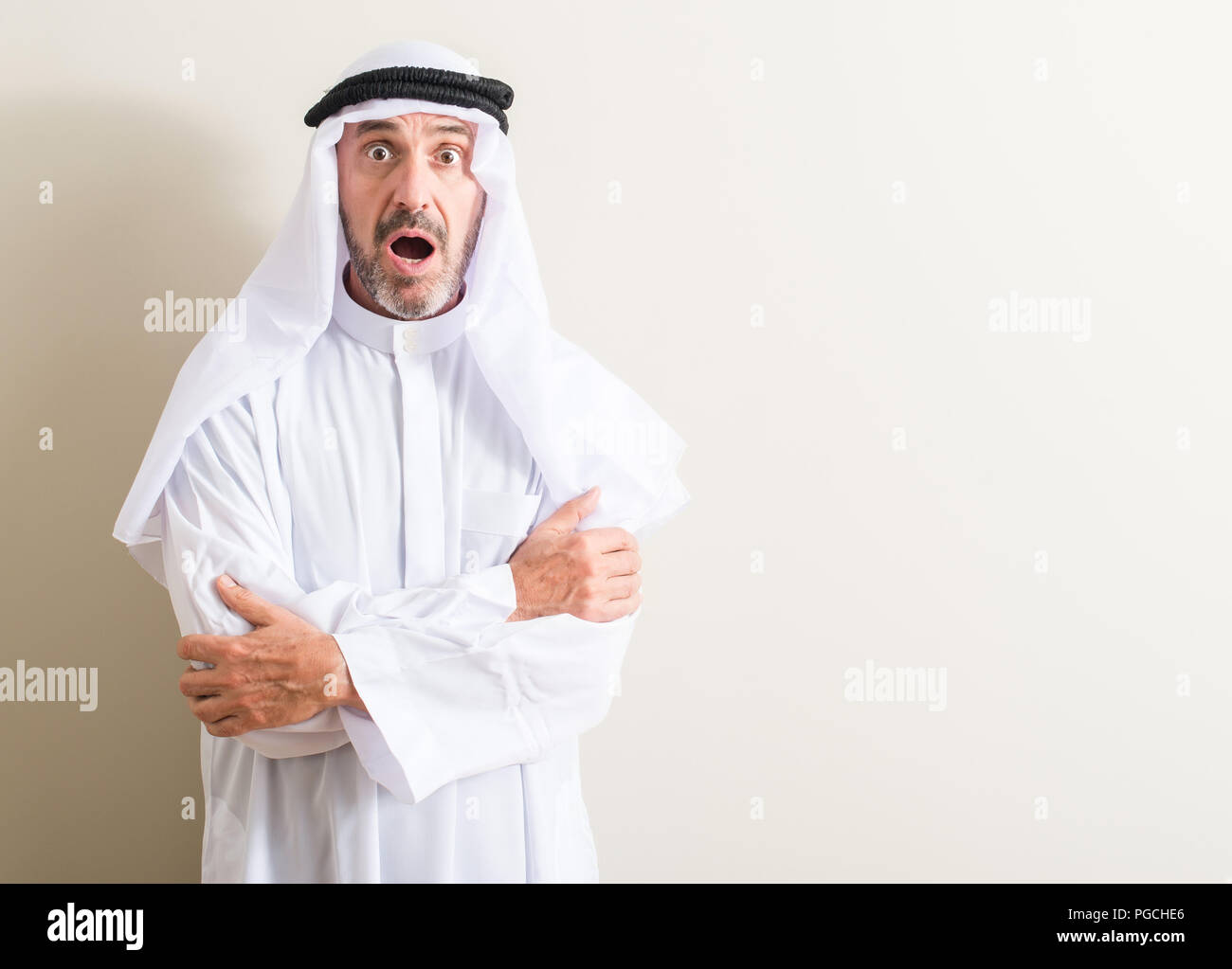 Senior arabic man scared in shock with a surprise face, afraid and ...