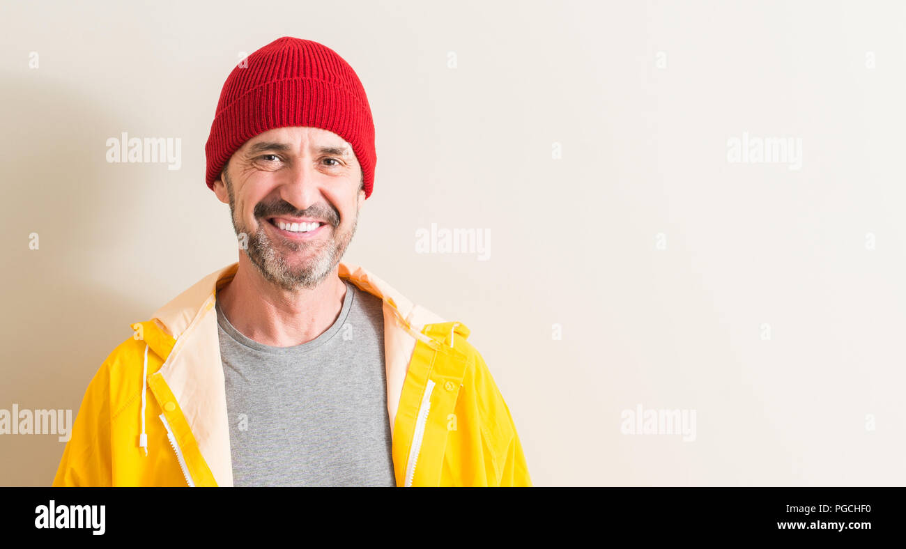 Senior fisherman with a happy face standing and smiling with a ...