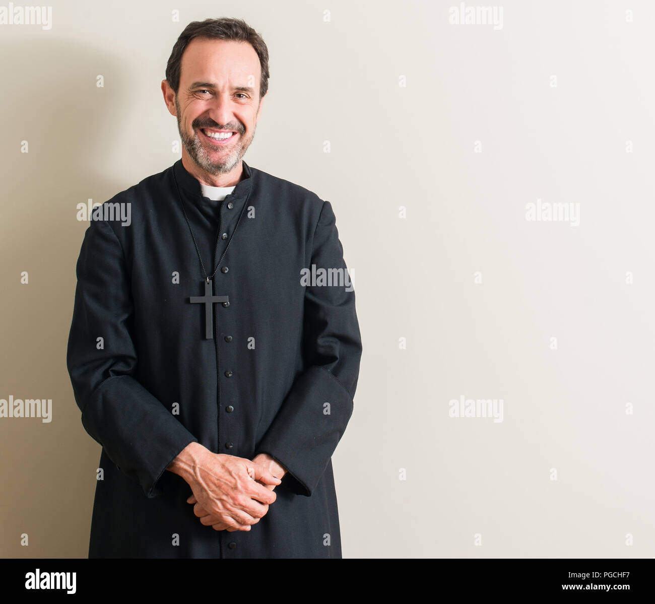 Senior priest religion man with a happy face standing and smiling with ...