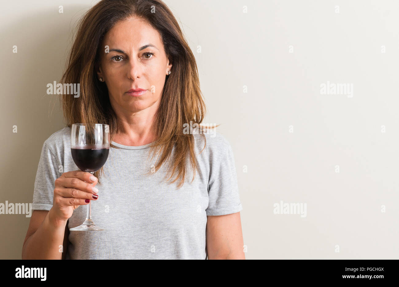 Angry woman holding a glass of wine hi-res stock photography and images ...