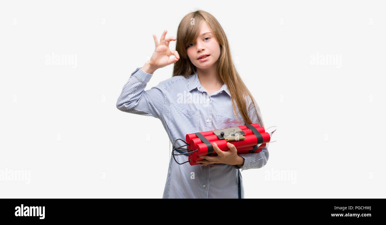 Young blonde child holding dynamite bomb doing ok sign with fingers ...