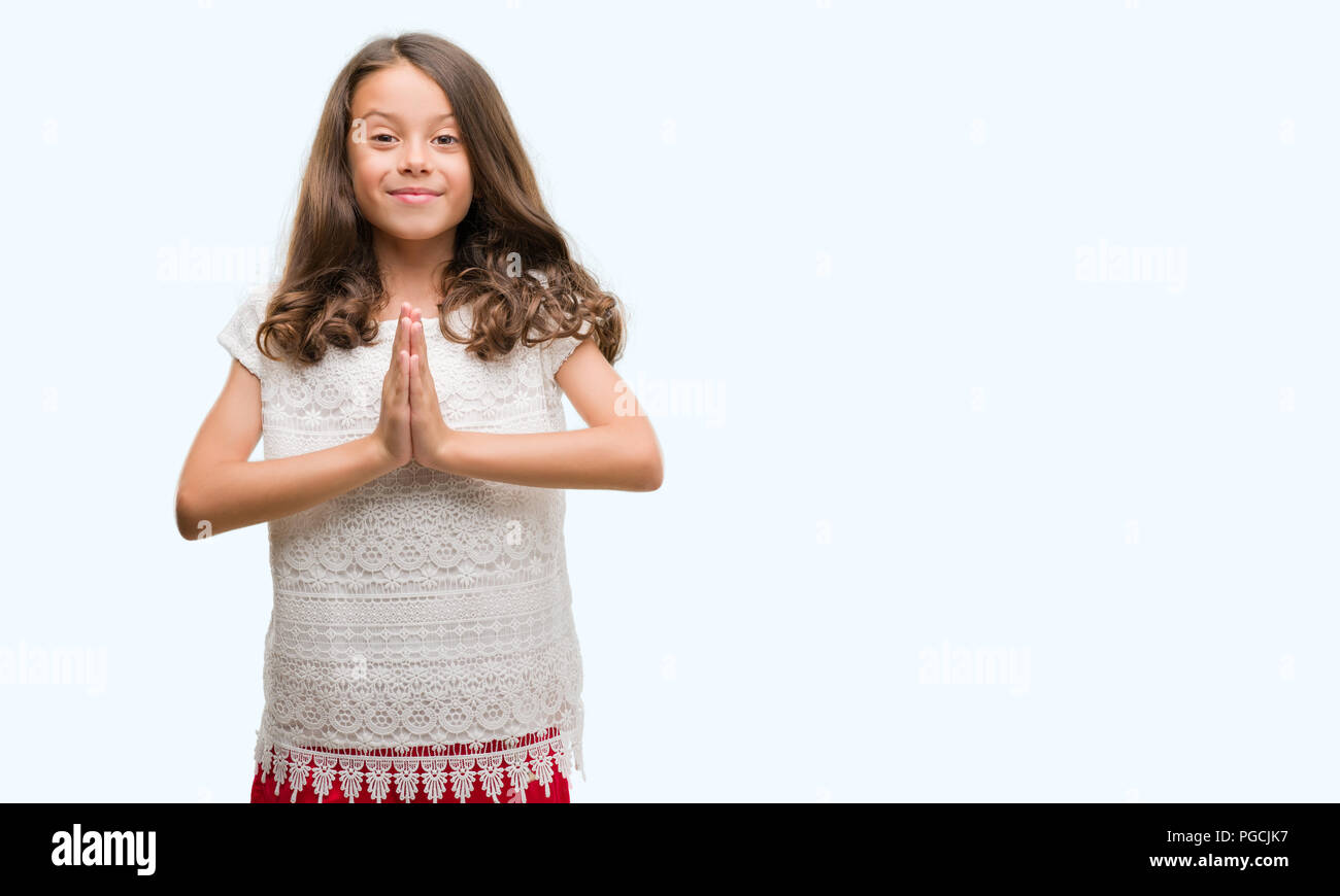 Brunette hispanic girl praying with hands together asking for ...