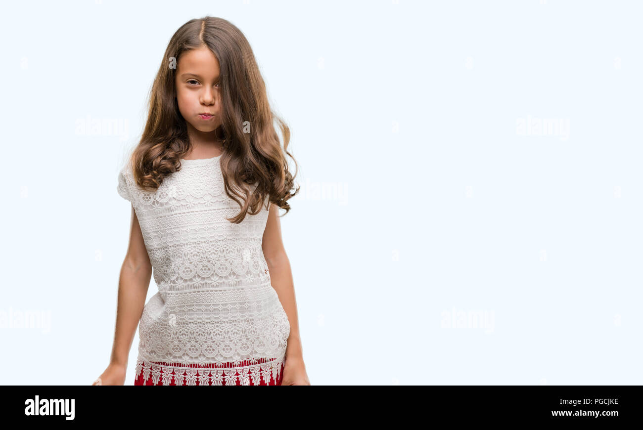 Brunette hispanic girl puffing cheeks with funny face. Mouth inflated ...