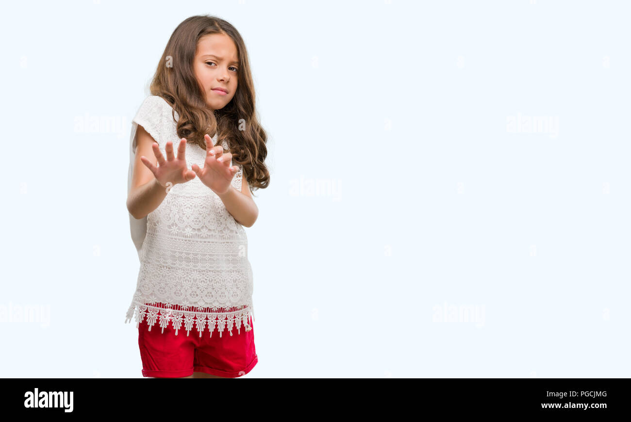 Brunette hispanic girl disgusted expression, displeased and fearful ...