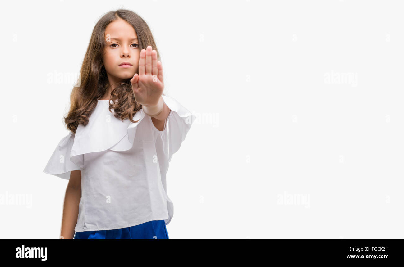 Brunette hispanic girl doing stop sing with palm of the hand. Warning ...