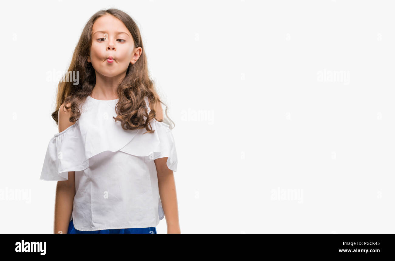 Brunette hispanic girl making fish face with lips, crazy and comical ...