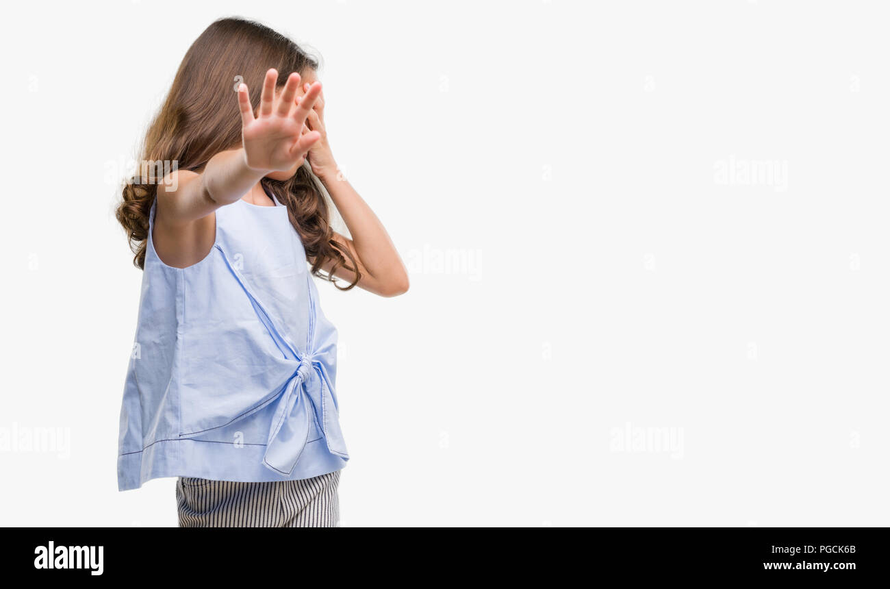 Brunette hispanic girl covering eyes with hands and doing stop gesture ...