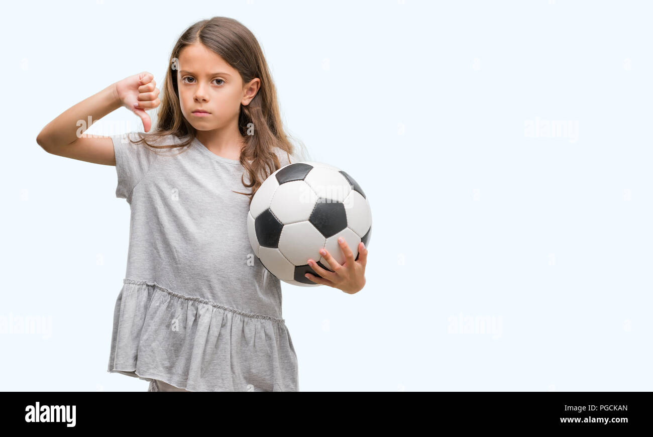 Brunette hispanic girl holding soccer football ball with angry face ...