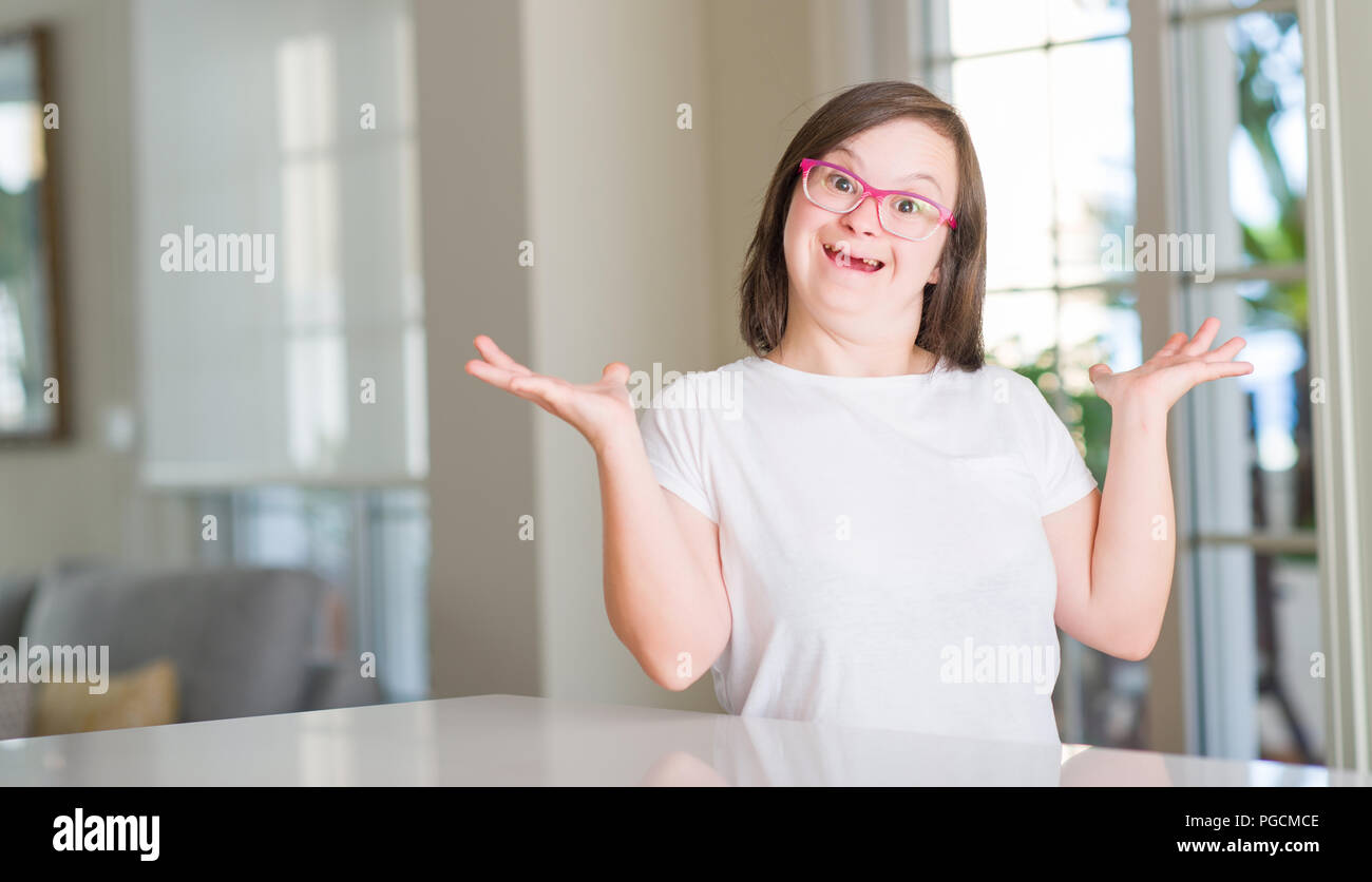Down syndrome woman at home very happy and excited, winner expression ...