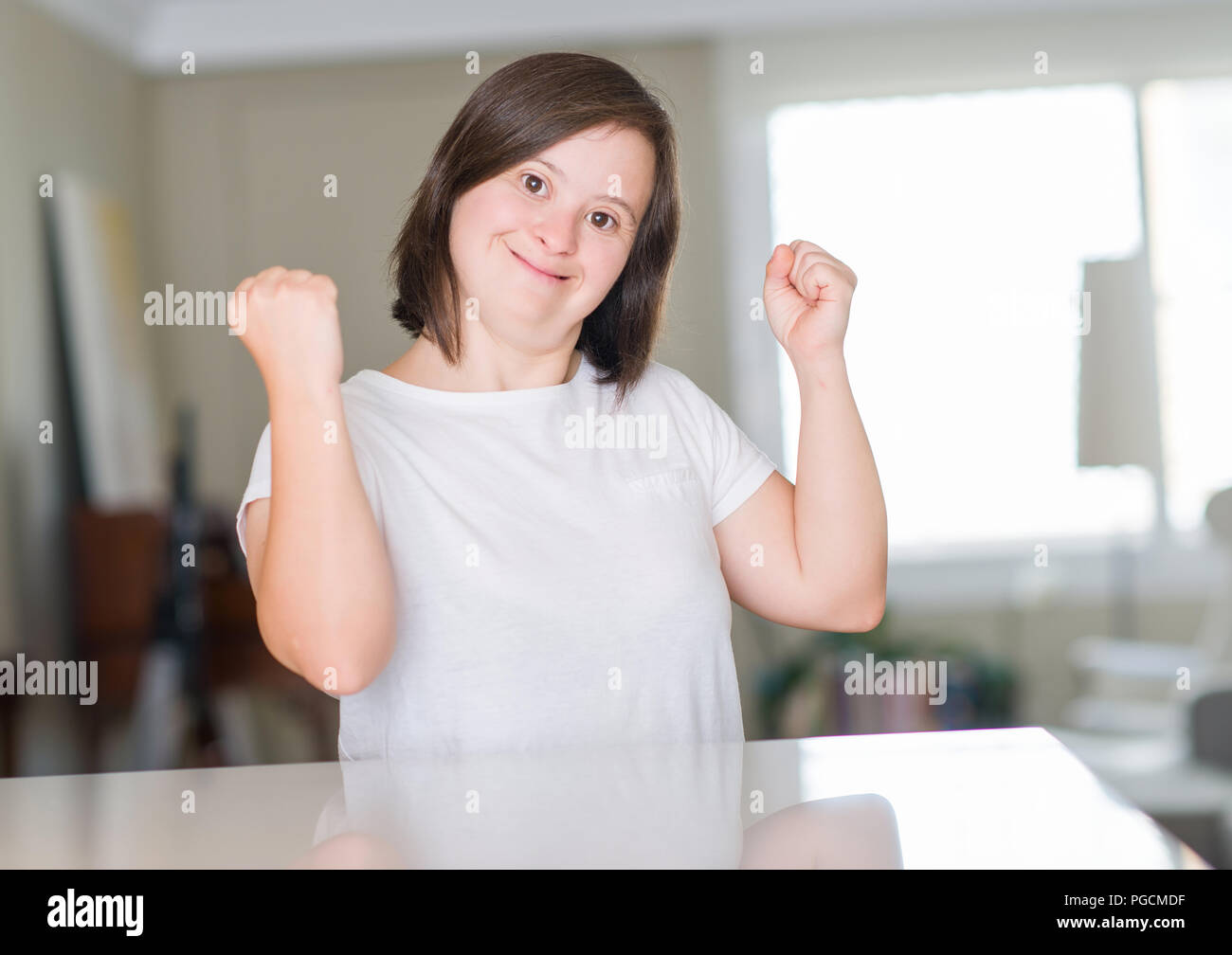 Down syndrome woman at home screaming proud and celebrating victory and ...
