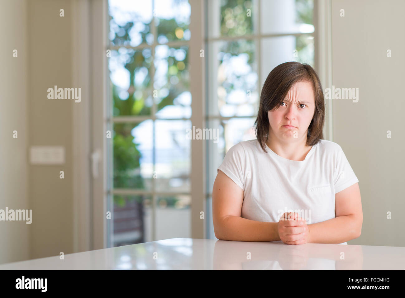 Down syndrome woman at home depressed and worry for distress, crying ...
