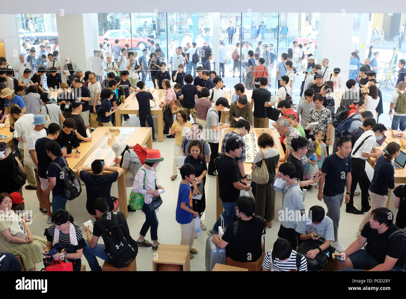Locals and tourists explore the Kyoto Apple Store on the city's main shopping street on 25th ...