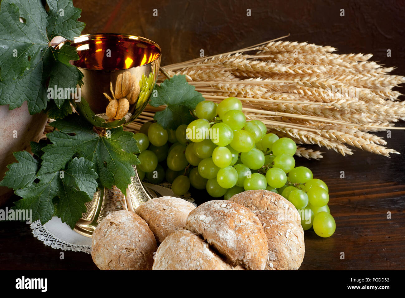Grapes and holy bread next to a golden chalice with wine Stock Photo ...