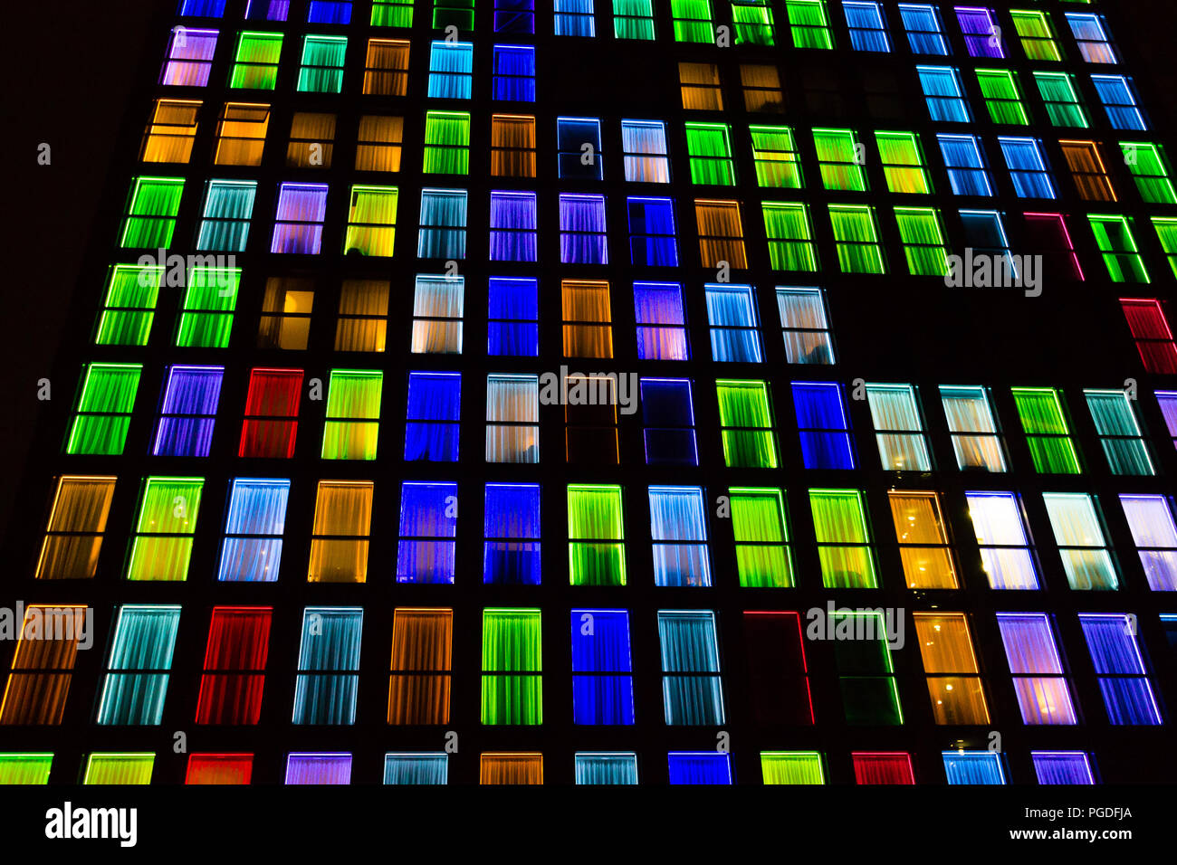 Colored windows texture. Windows illuminated by neon lights background ...