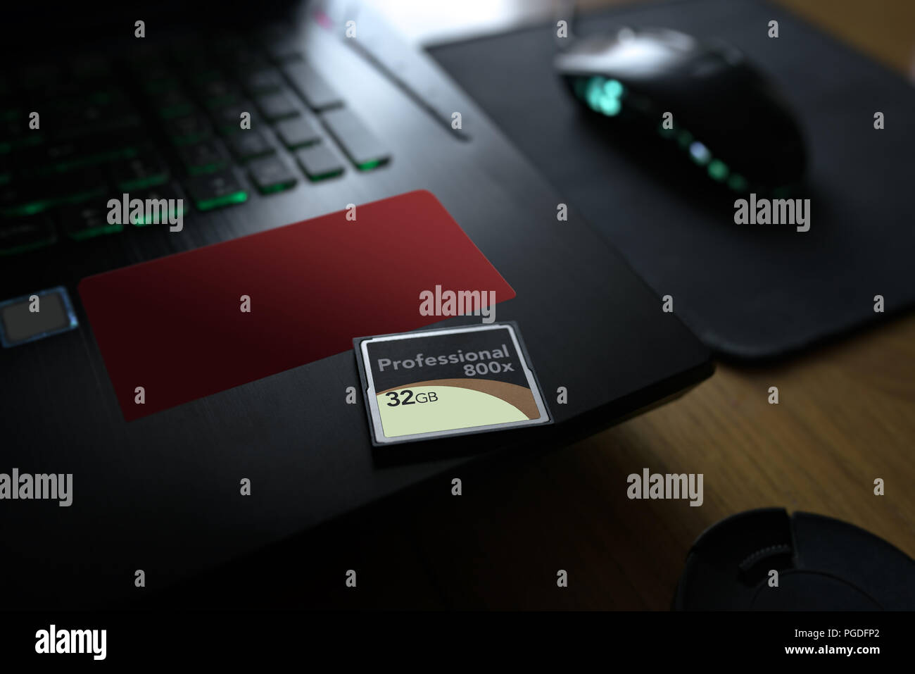 Memory card 32 GB lying on the black modern notebook keyboard with ...