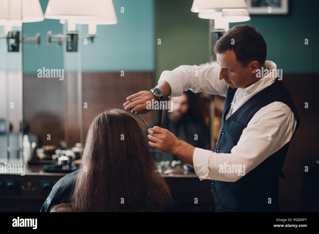 Barbershop with wooden interior. Bearded model man and barber Stock ...