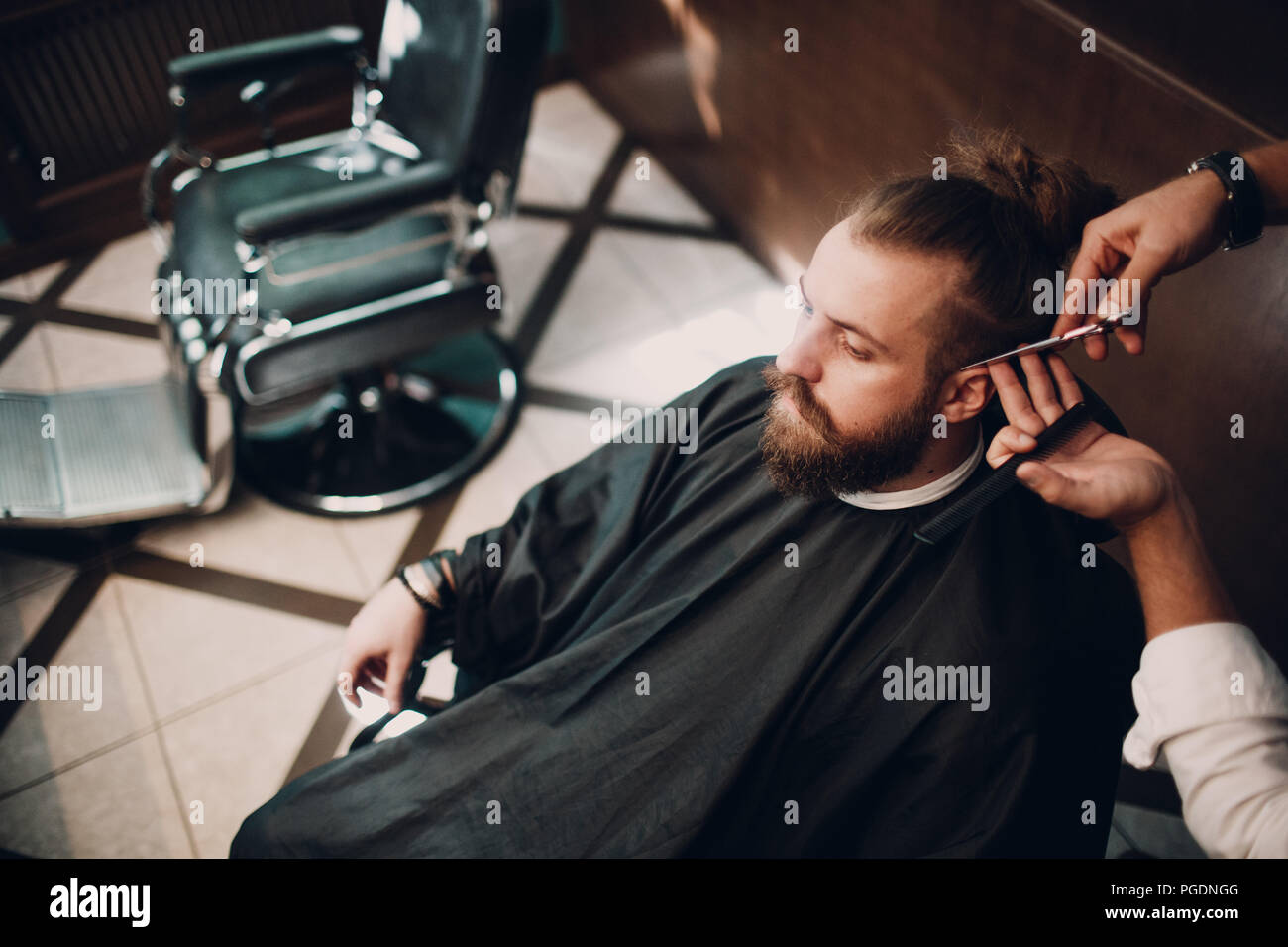 Barbershop with wooden interior. Bearded model man and barber Stock ...