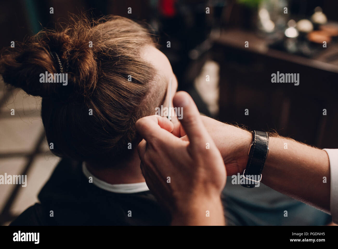 Barbershop with wooden interior. Bearded model man and barber Stock ...