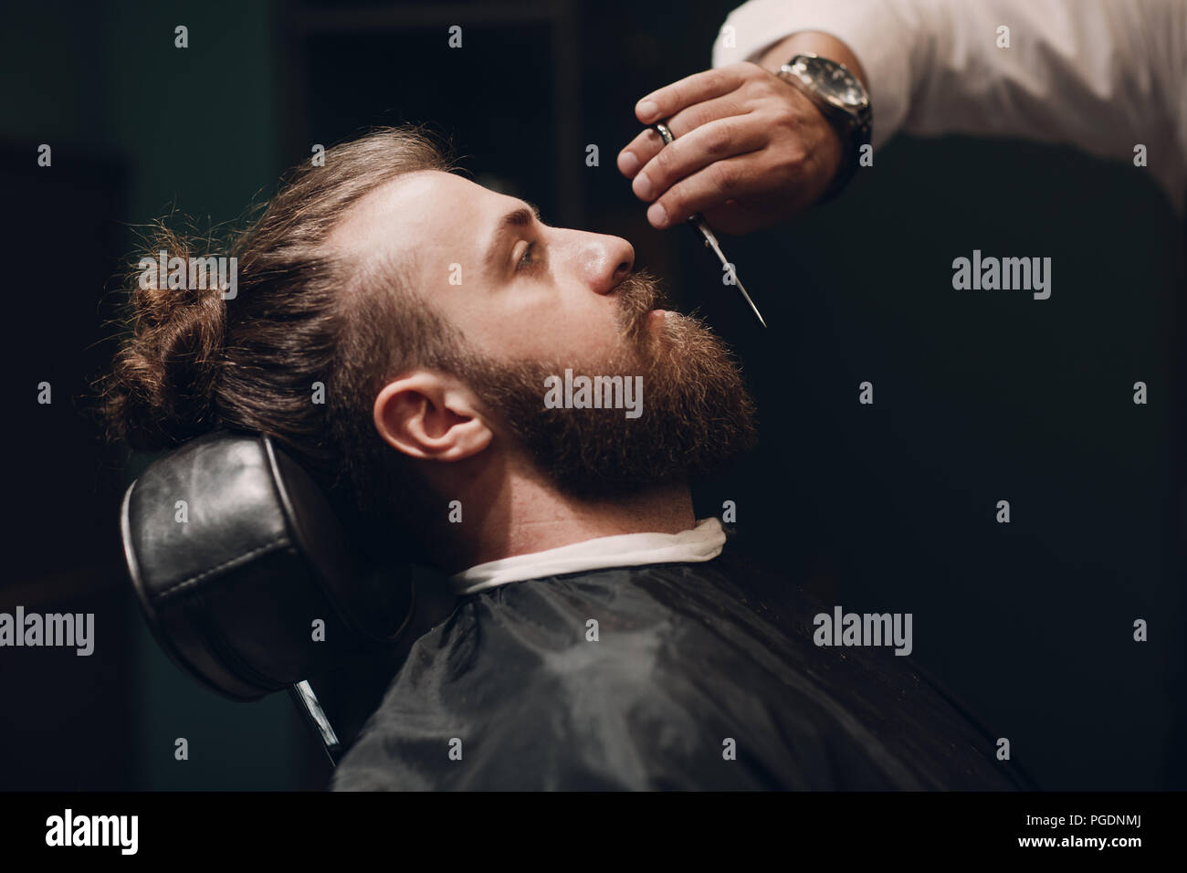Barbershop with wooden interior. Bearded model man and barber Stock ...