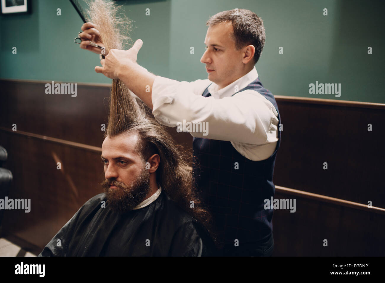 Barbershop with wooden interior. Bearded model man and barber Stock ...