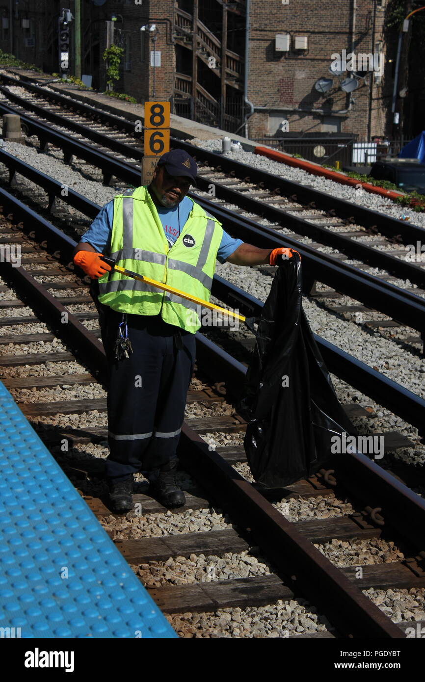 CTA red line worker smiling and working hard collecting garbage on the ...