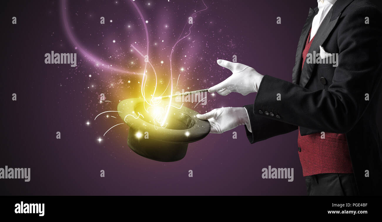 Magician hand conjure with wand light from a black cylinder Stock Photo ...