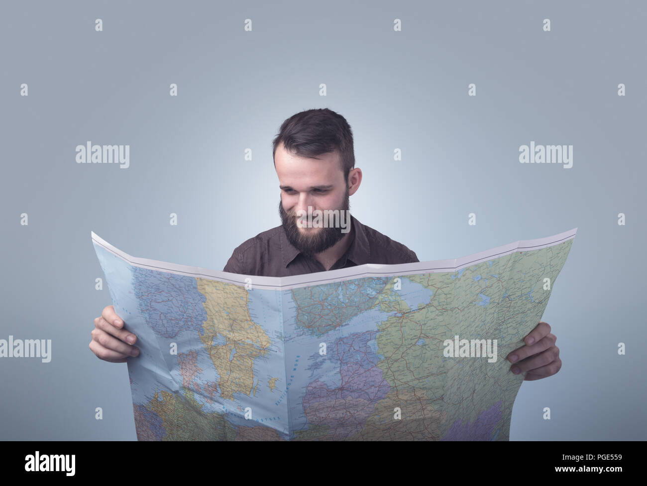 Handsome young man holding map Stock Photo - Alamy