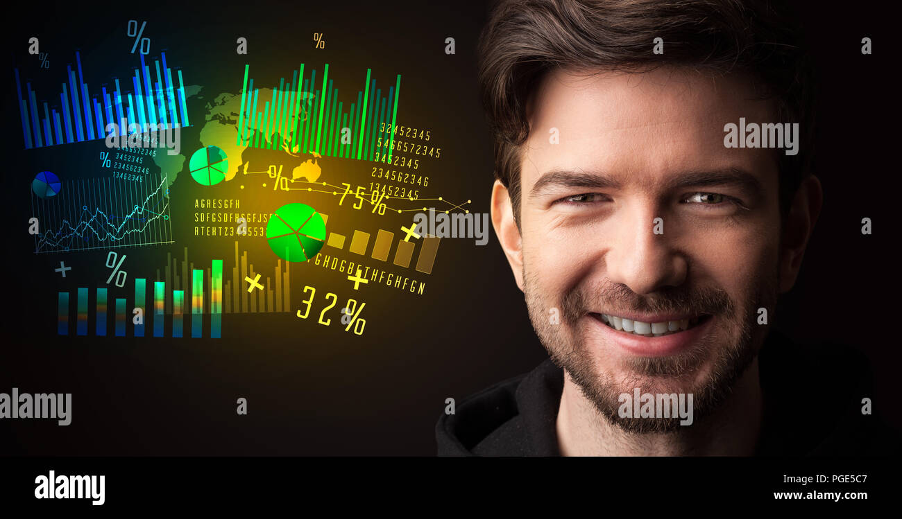 Portrait of a young businessman with colorful charts and graphs next to ...