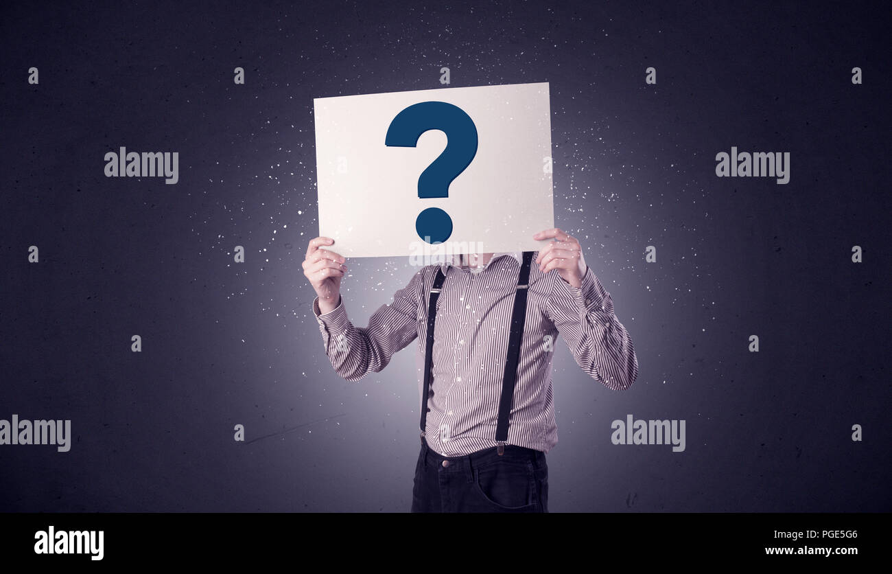 Young businessman hiding behind a question mark drawn on paper Stock ...