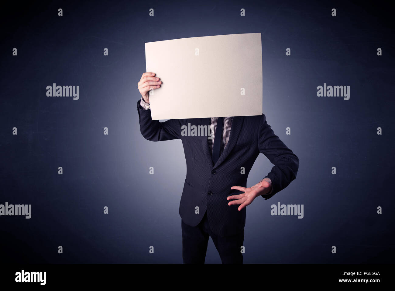 Businessman standing and holding a blank sheet of paper hi-res stock ...