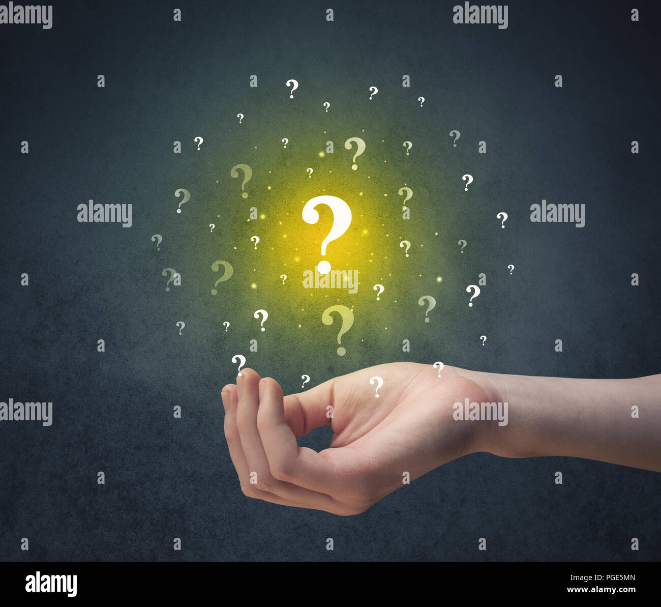 Yellow question marks hovering over young hand Stock Photo - Alamy