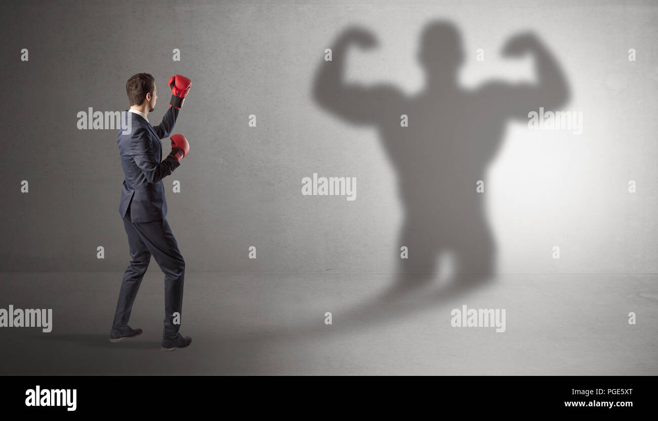 Businessman fighting with his bossy yelling shadow Stock Photo - Alamy