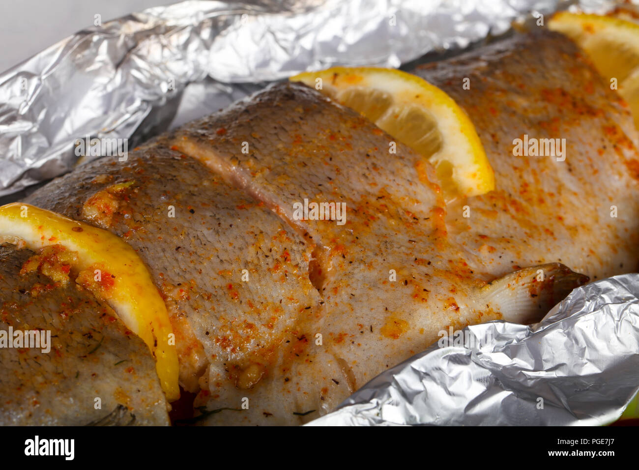 Roasted trout with tomato and lemon Stock Photo - Alamy