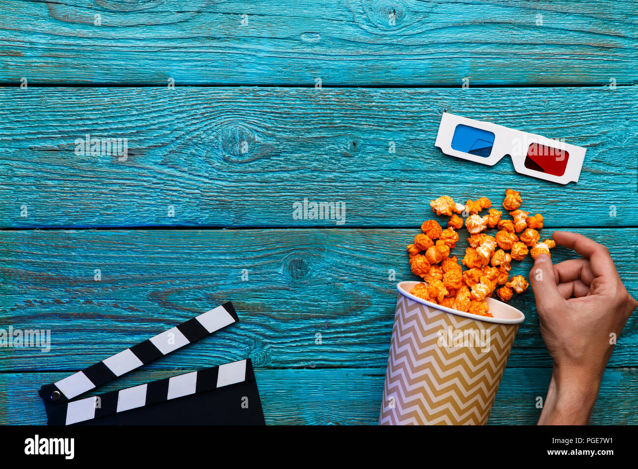 People eating popcorn. Human hands. Top view Stock Photo - Alamy