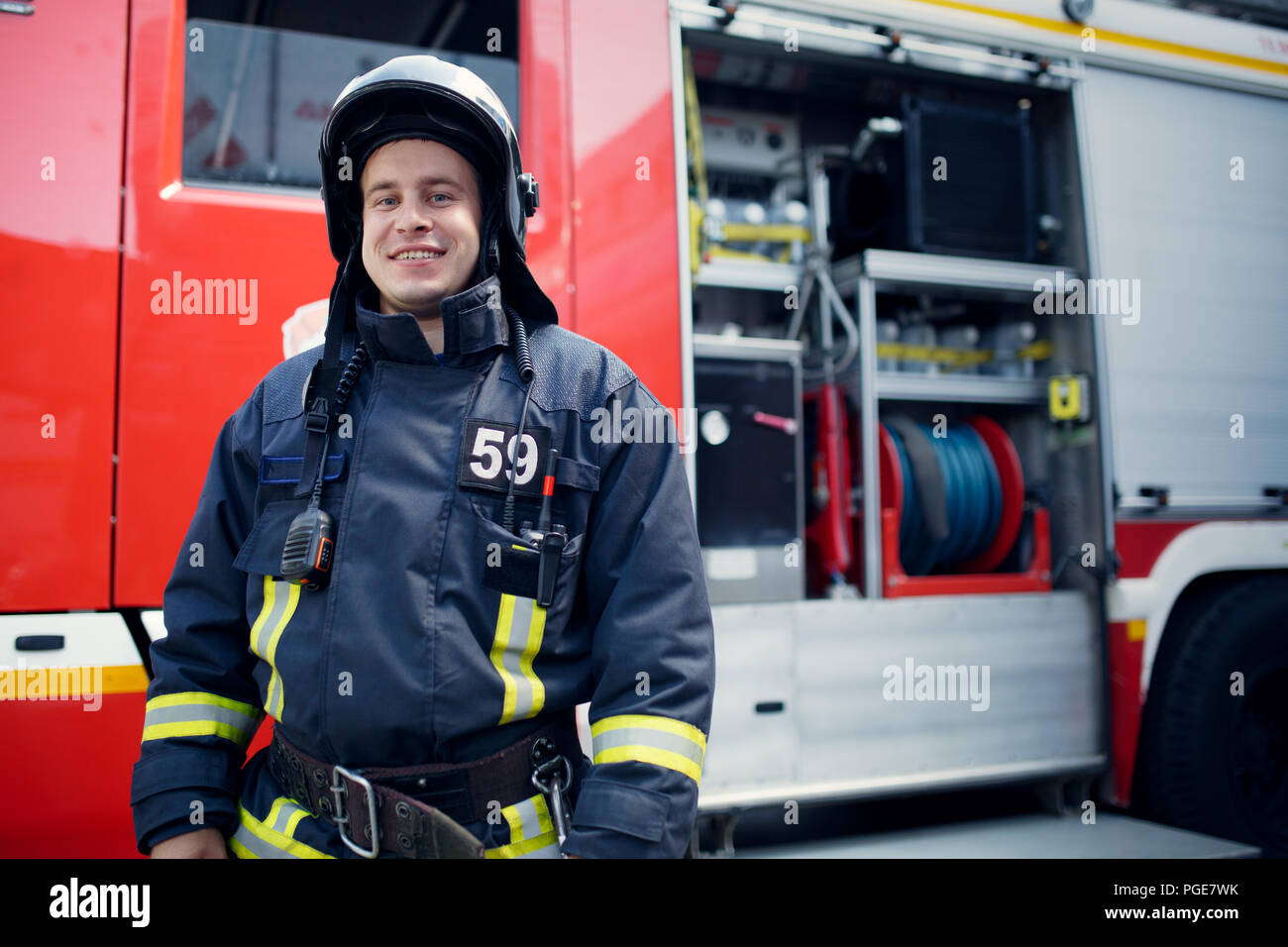 Photo of fireman in front of fire engine Stock Photo - Alamy