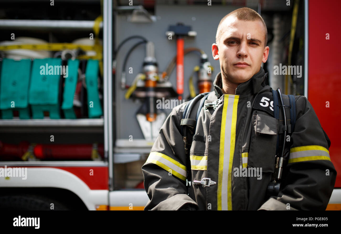 Photo of fireman near fire engine Stock Photo - Alamy