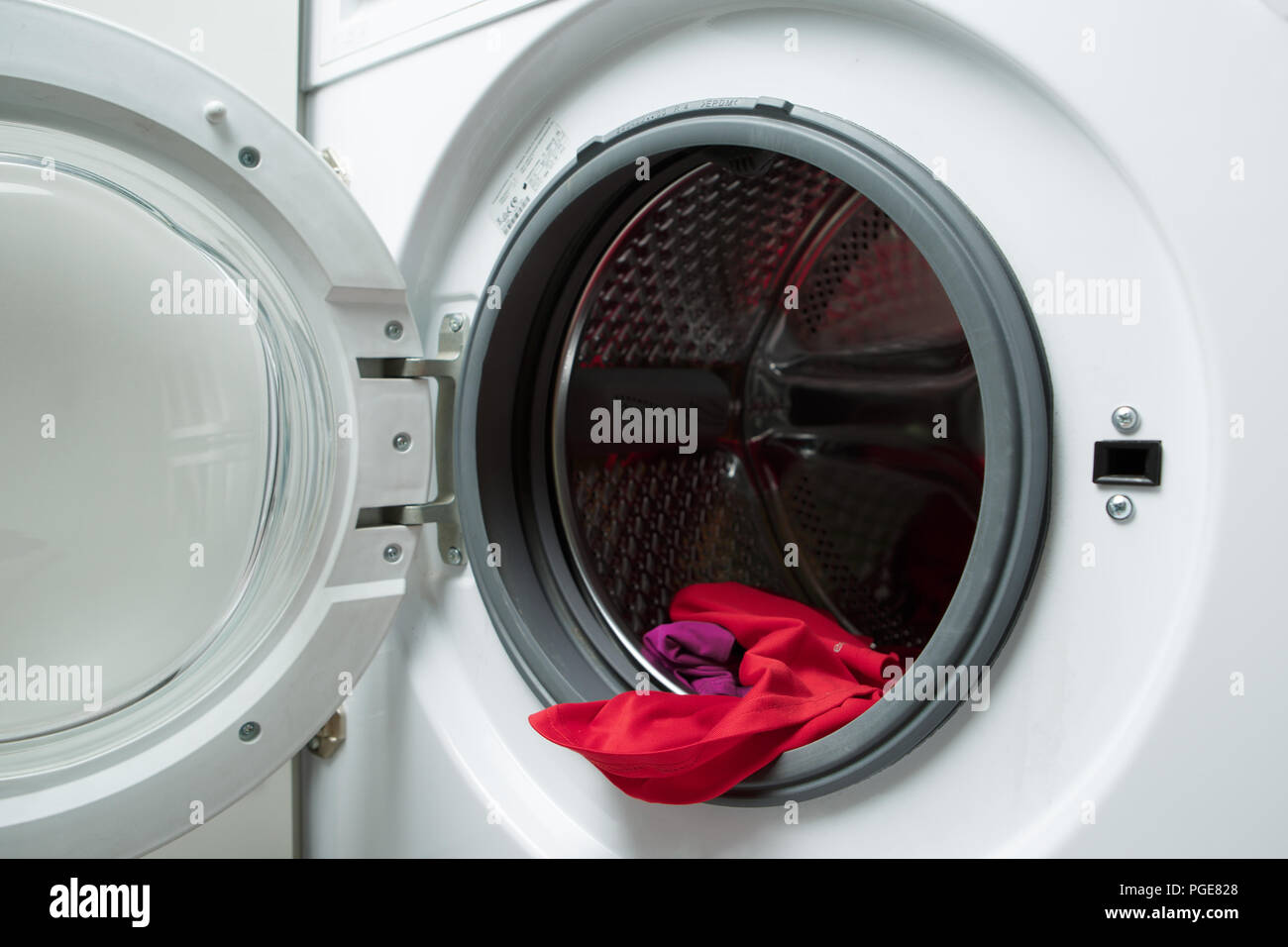 Image of open washing machine with red cloth Stock Photo - Alamy