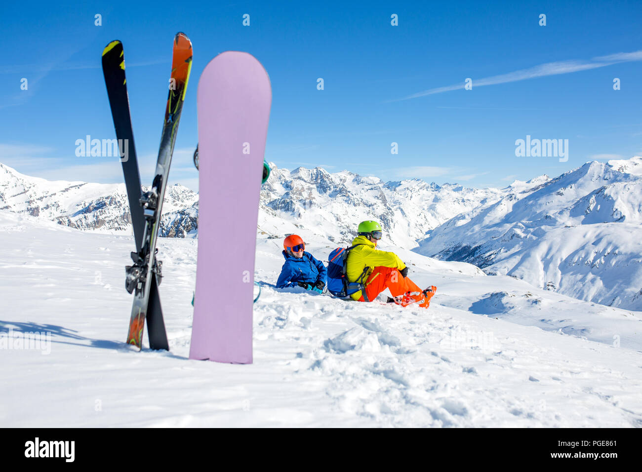 snowboarder and skiier sitting on snow and see at mountains Stock Photo ...