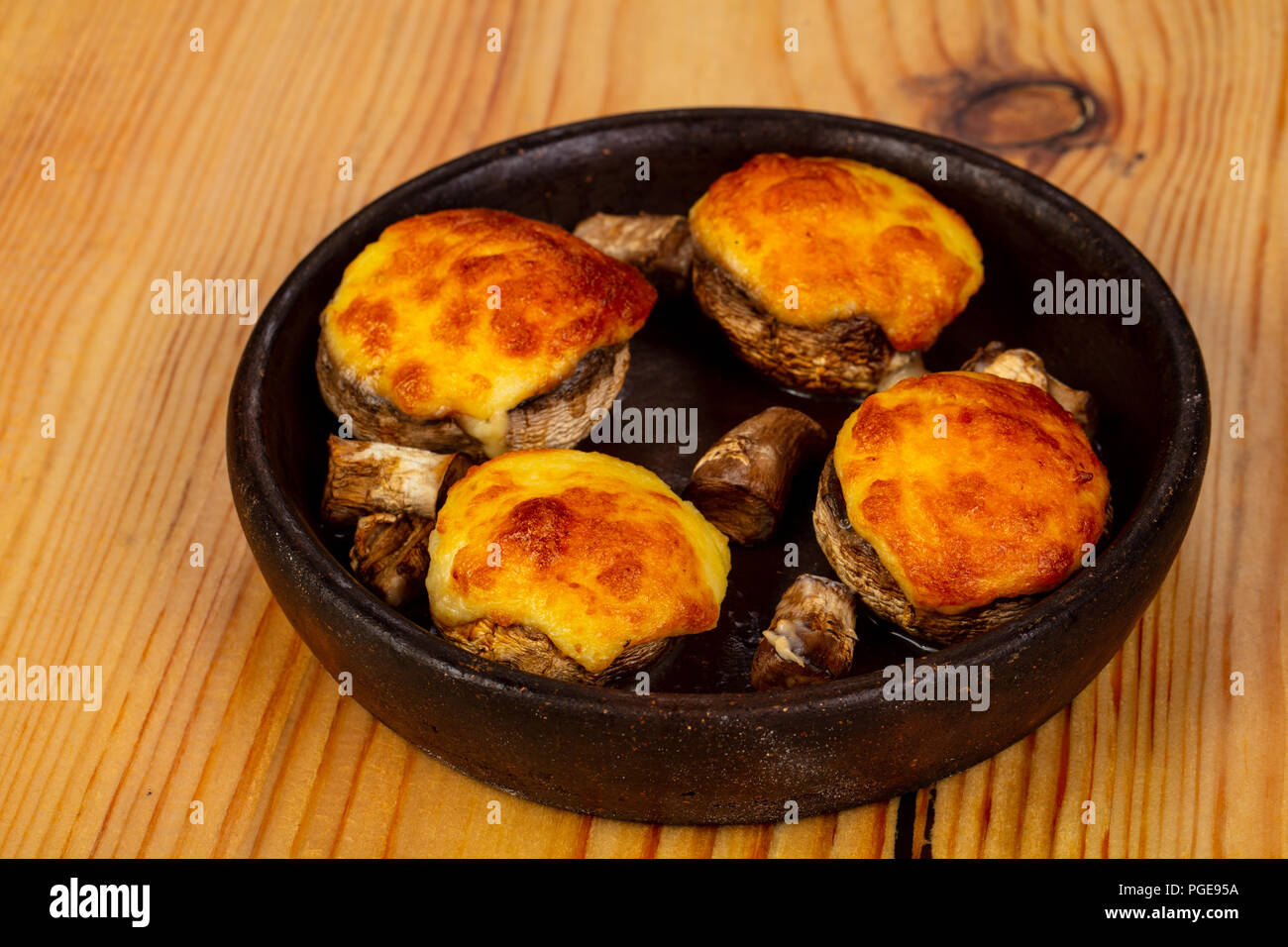 Baked champignon with cheese in the pan Stock Photo - Alamy