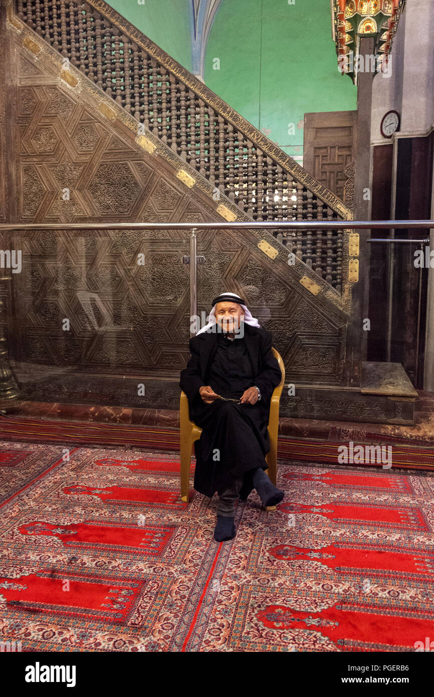 Hebron, Palestine, June 21, 2014: A Palestinian elderly man sits on a ...