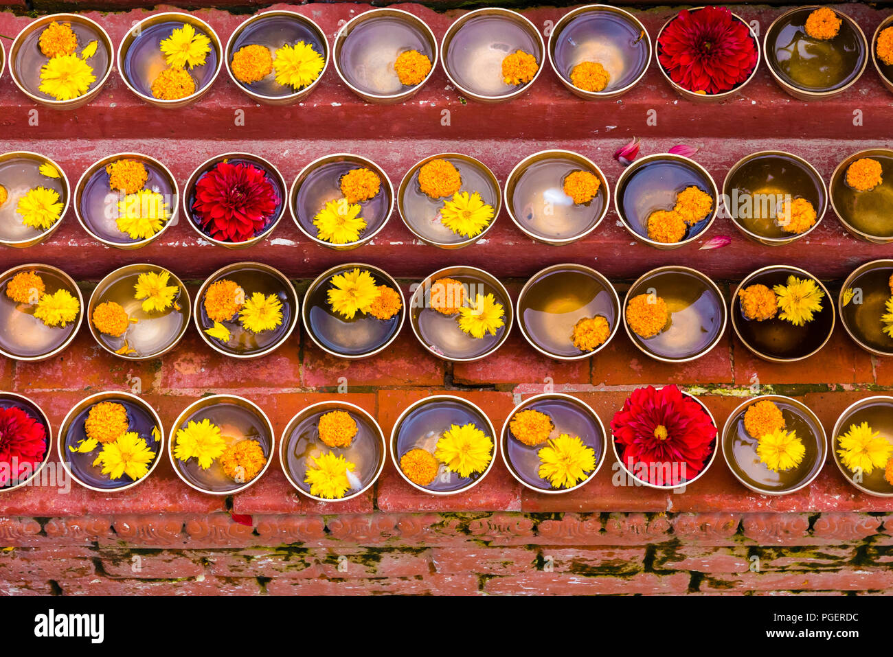 Close-up on Buddhist flower offerings in bowls. In Buddhism symbolic ...