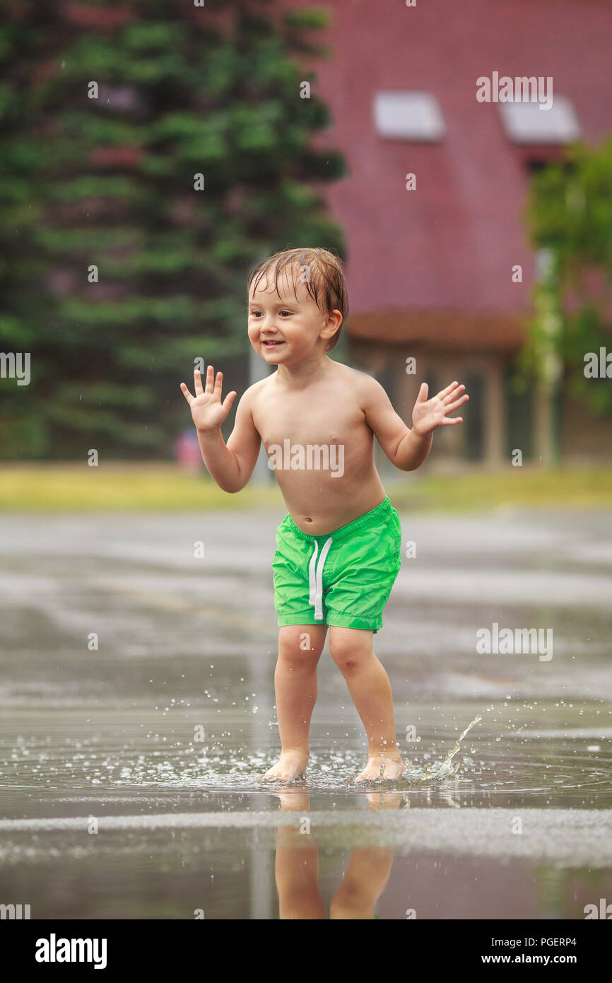 Boy jumping in puddle hi-res stock photography and images - Alamy