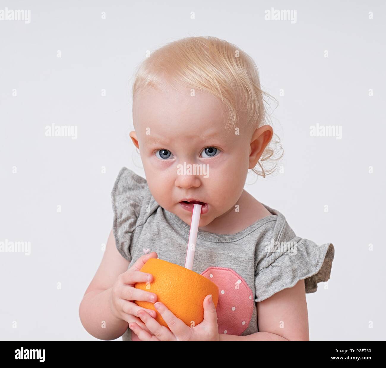 Happy kid drinking fresh juice Stock Photo - Alamy