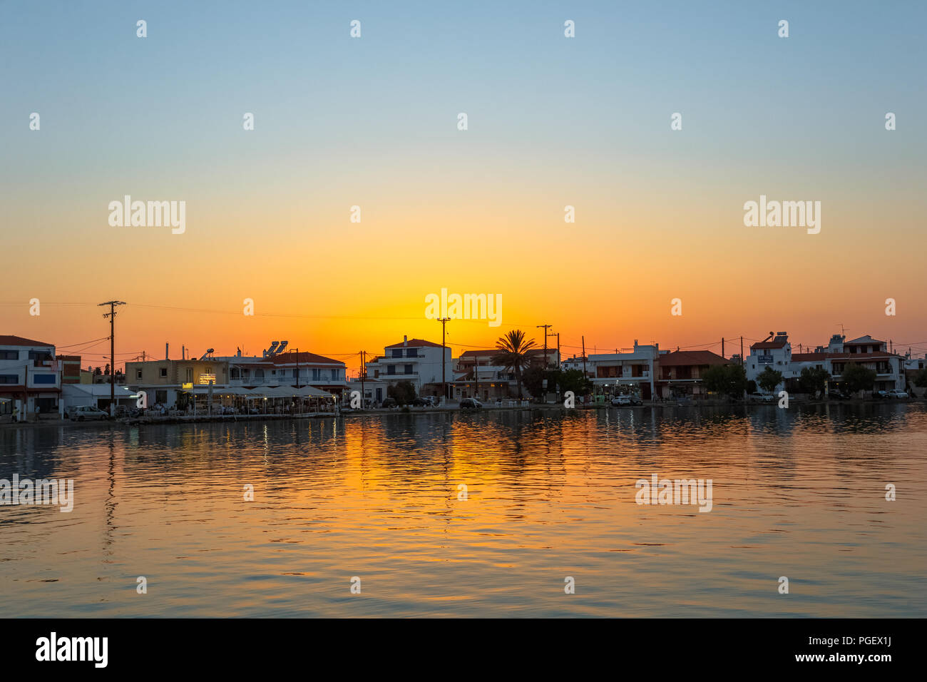 Elafonisos village against the setting sun, a beautiful fish village in ...