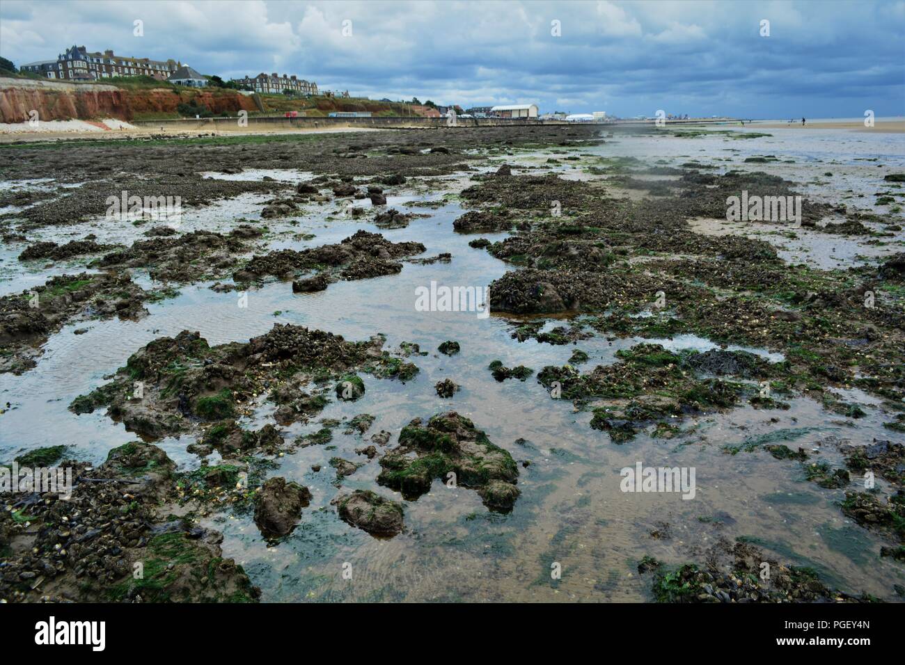 Hunstanon beach, with rock pools and storm clouds blowing in Stock ...