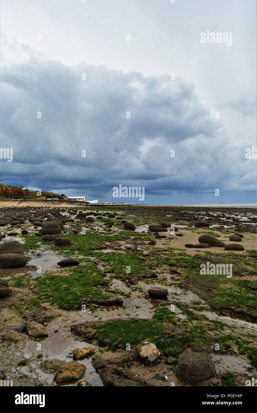 Hunstanon beach, with rock pools and storm clouds blowing in Stock ...