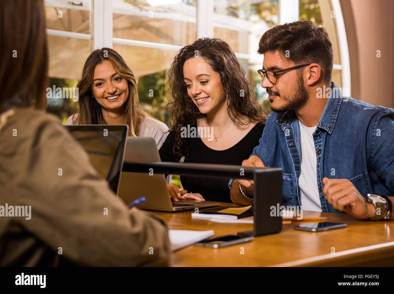 Groups of friends studying together on the bibliotech Stock Photo - Alamy