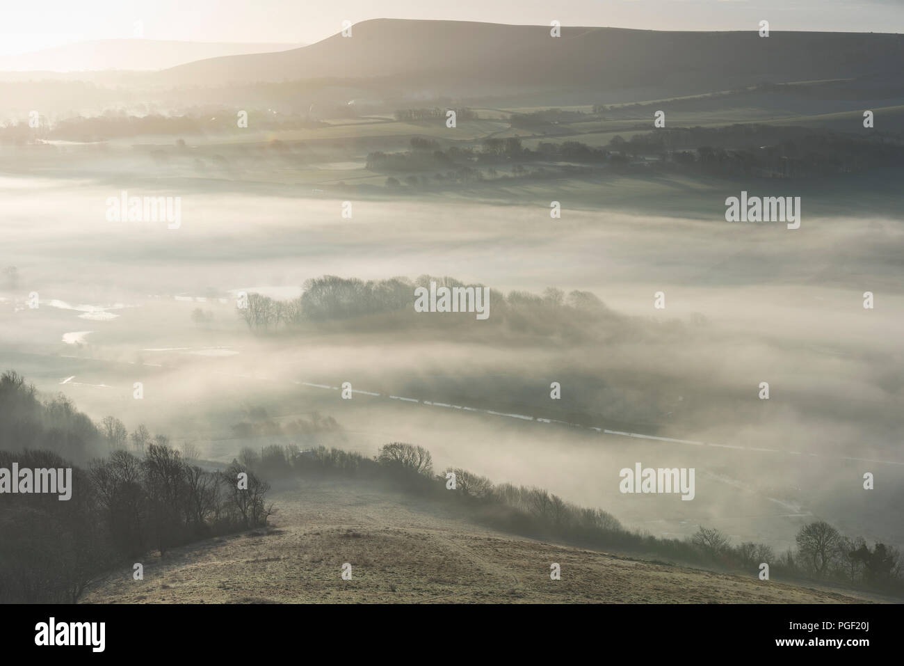 Beautiful foggy English countryside landscape at sunrise in Winter with ...