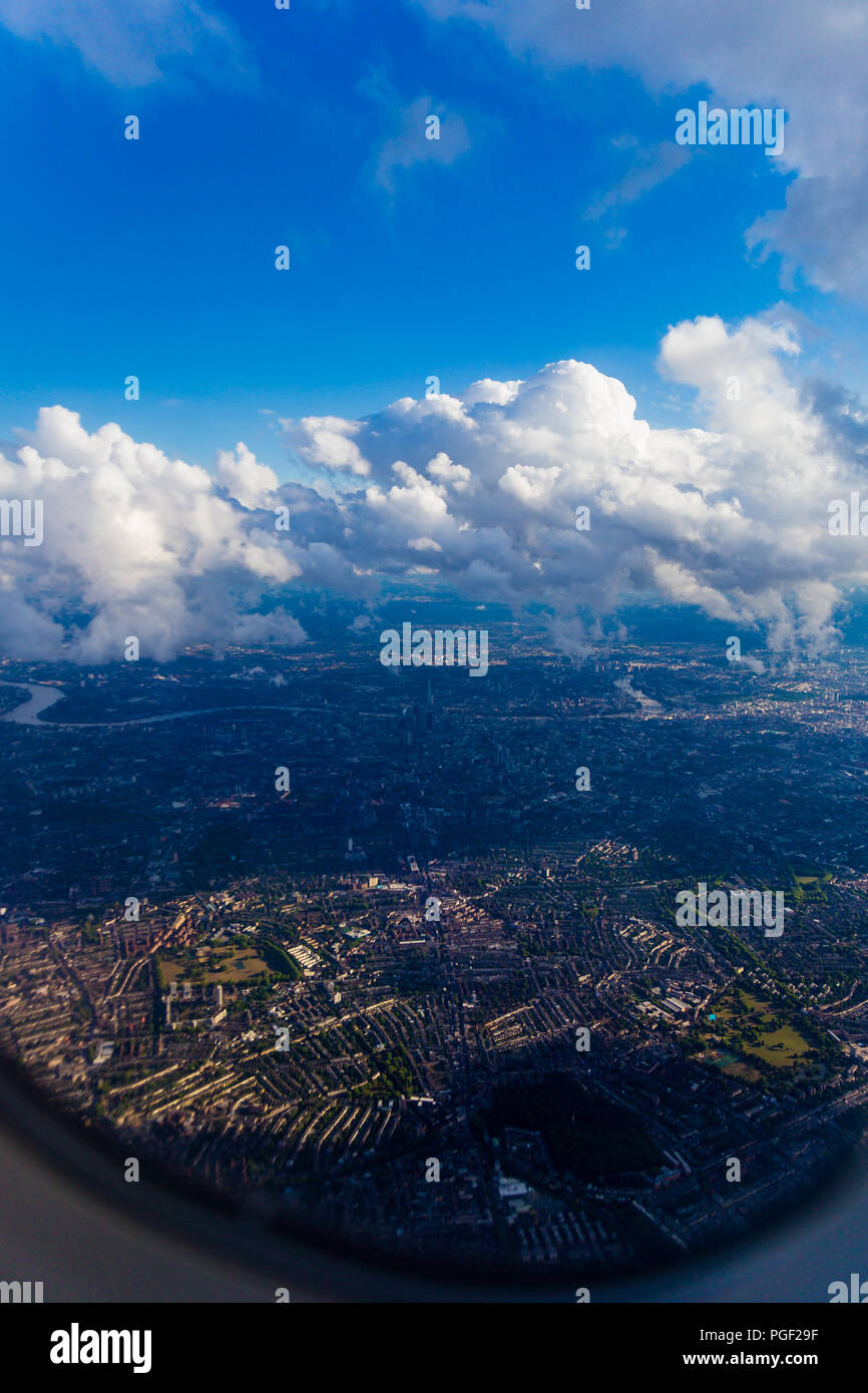 aerial view of the city of London from airplane window seat approaching ...